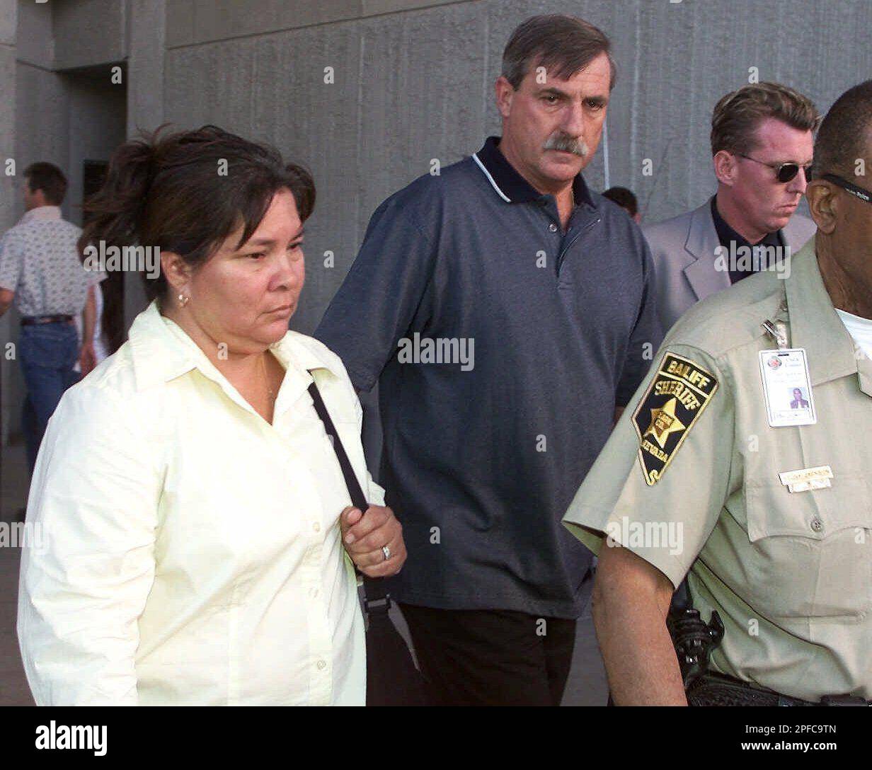 Sandy Murphy, left, and her husband, Kenneth Murphy, are escorted from the Clark County ...