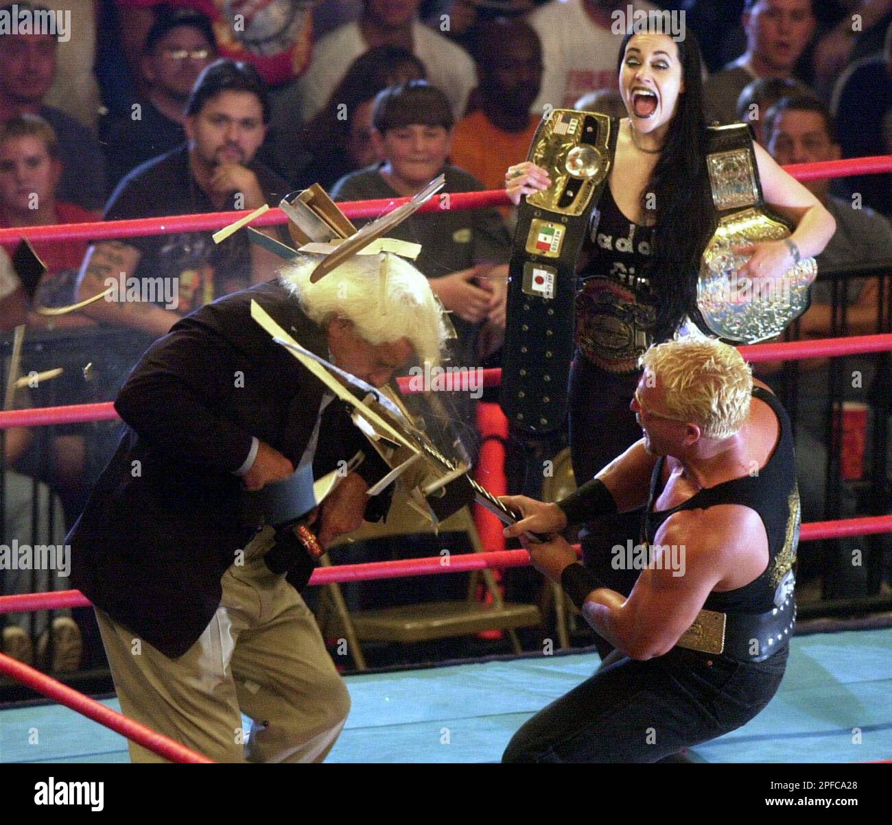 Professional wrestler Jeff Jarrett, right, smashes a guitar over the ...