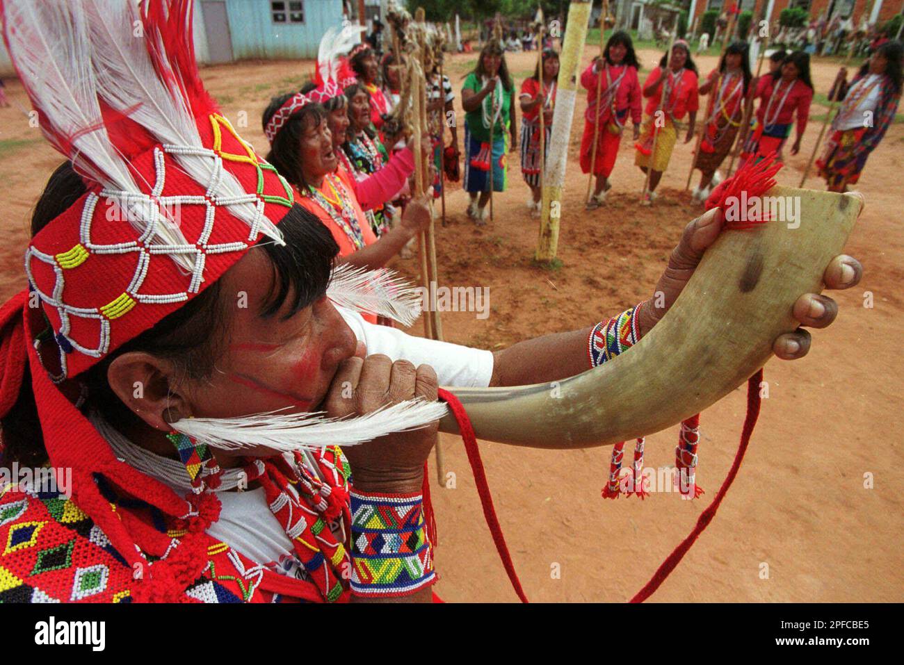 A member of the Maka tribe blows a Turu, musical instrument made of ...