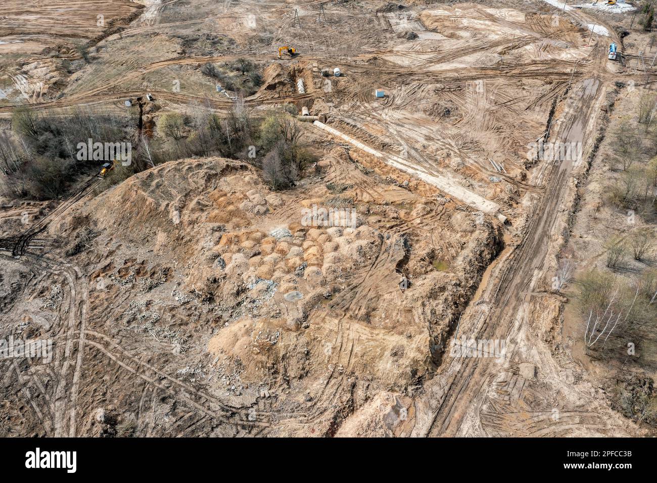 laying of underground storm sewer pipes at construction site. panoramic ...