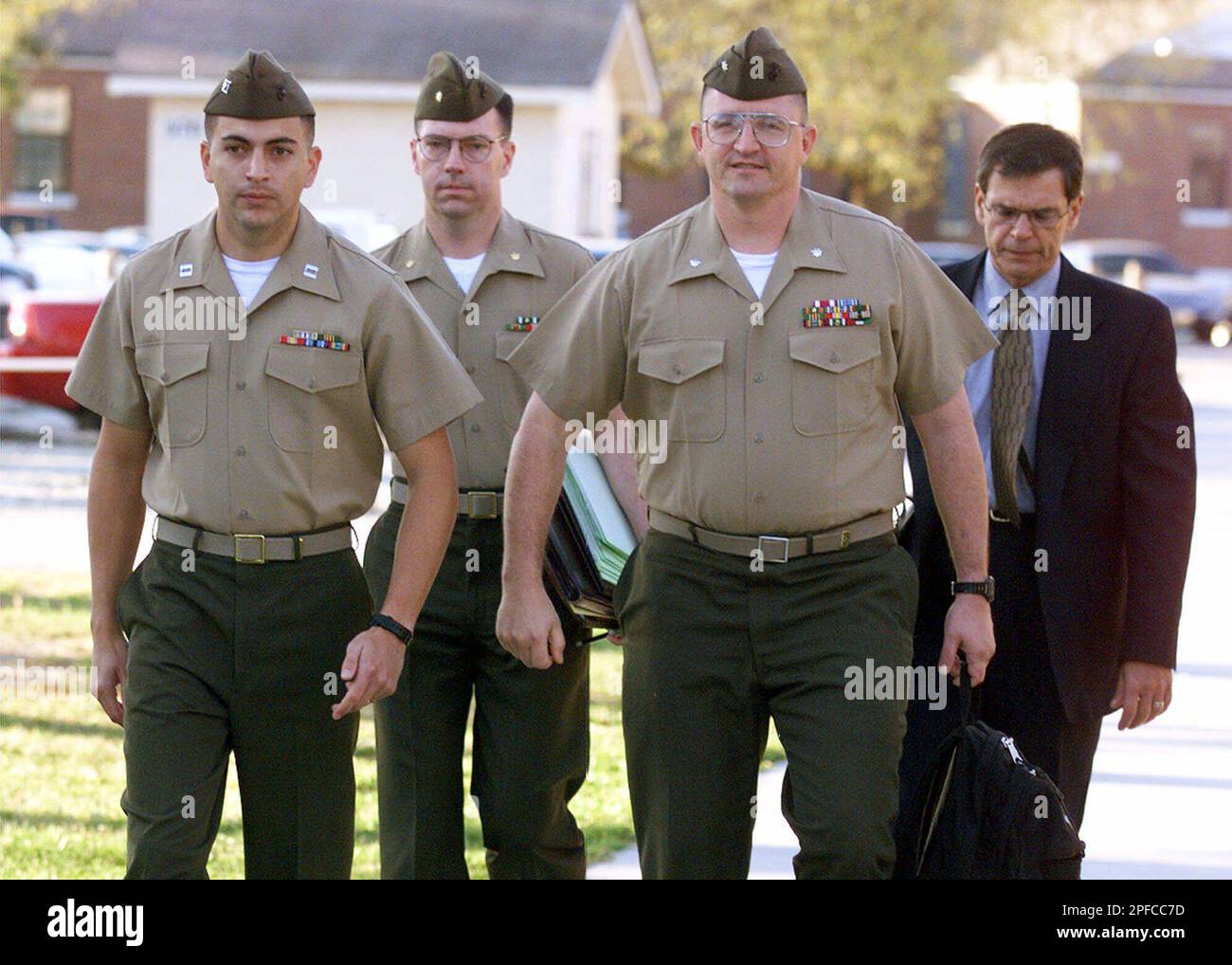 Marine Capt. Victor Arana, left, walks to court with his defense team ...