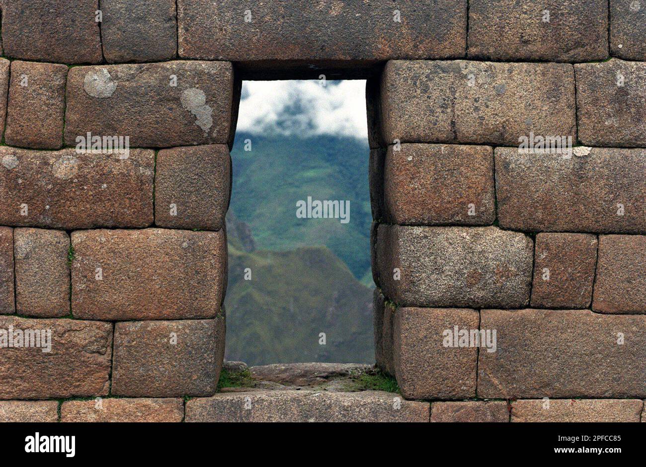 FOR IMMEDIATE RELEASE--Mountains are seen through a trapezoidal window ...