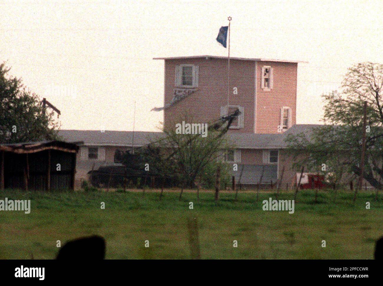 An armored vehicle drives past the Branch Davidian compound near Waco ...