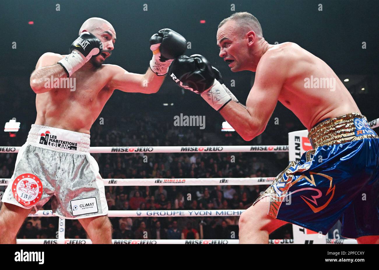 Laval, Canada. 16th Mar, 2023. Mathieu Germain of Canada, left, trades ...