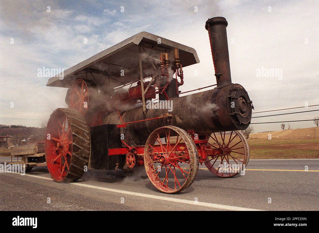 A 1923 Frick steam engine tractor called the Eclipse crawls along ...