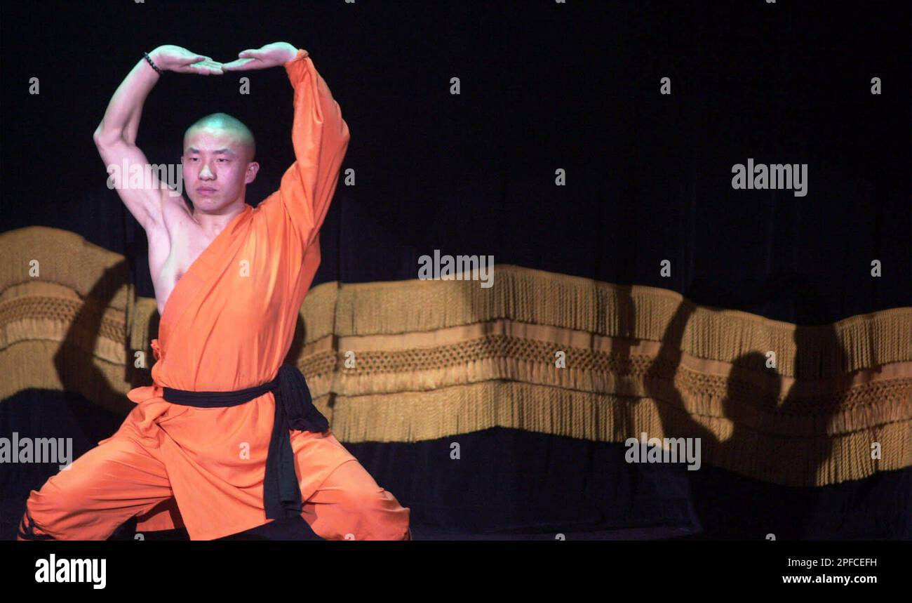Shi De-Xun, a Shaolin Monk from China, performs a Kung Fu technique ...