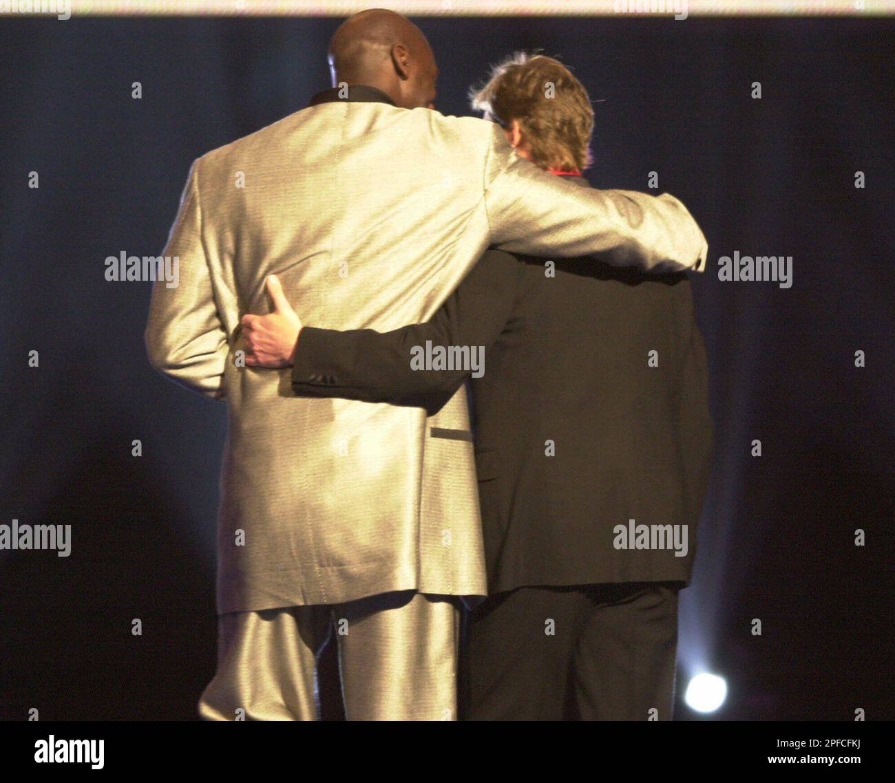 Michael Jordan and Wayne Gretzky walk off the stage arm-in-arm during ...