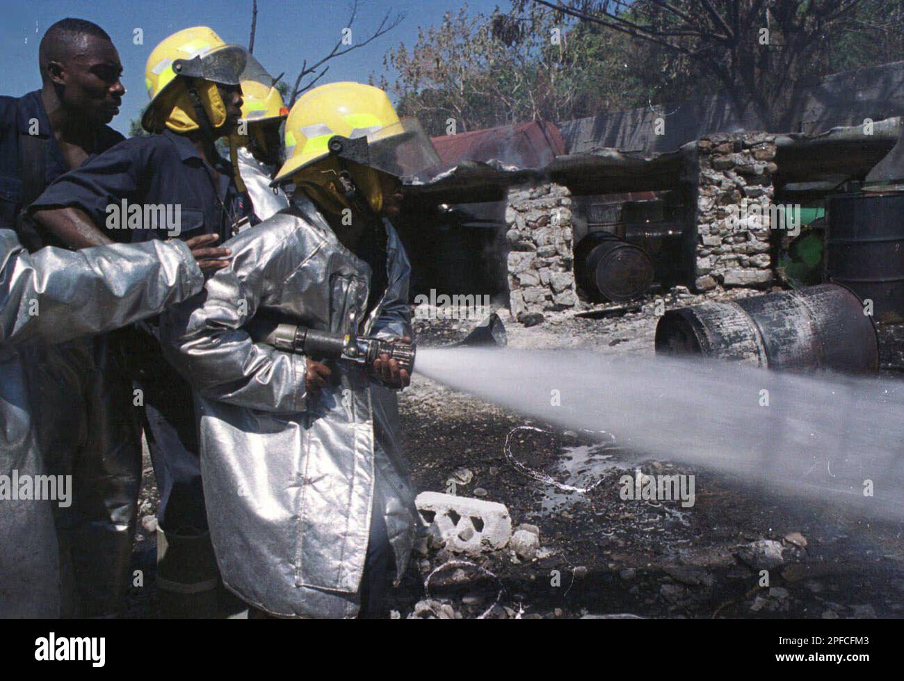 Haitian firefighters try to control the fire after more than 20,000 ...