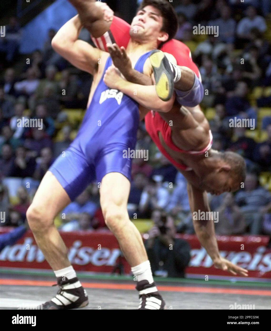Eric Guerrero, left, of Stillwater, Okla., flips Cuban wrestler Yoendry Albear prior to ...