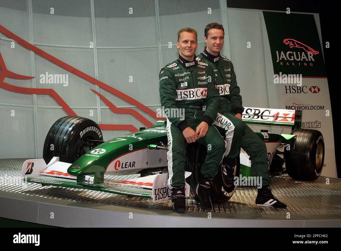 British drivers Johhny Herbert, left, and Eddie Irvine sit on the wheel ...