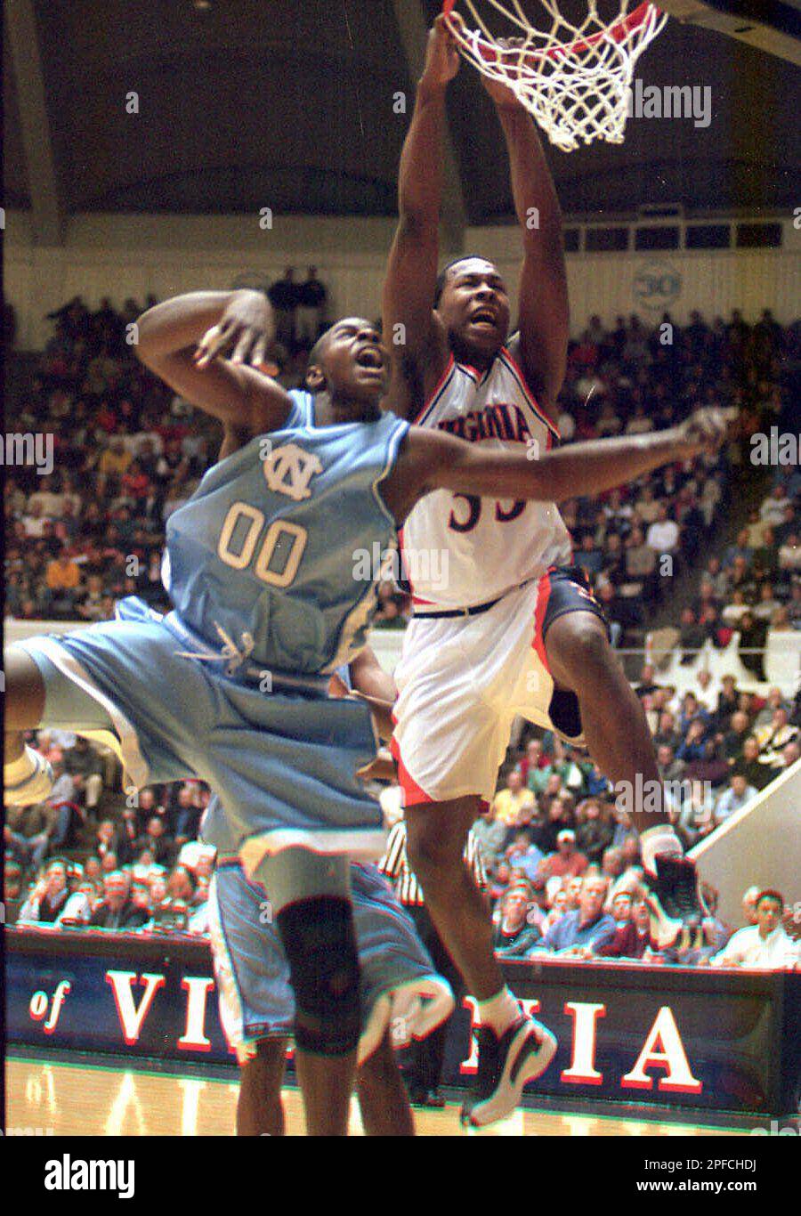 Virginia's Travis Watson hangs on the basket after a missing a dunk as ...
