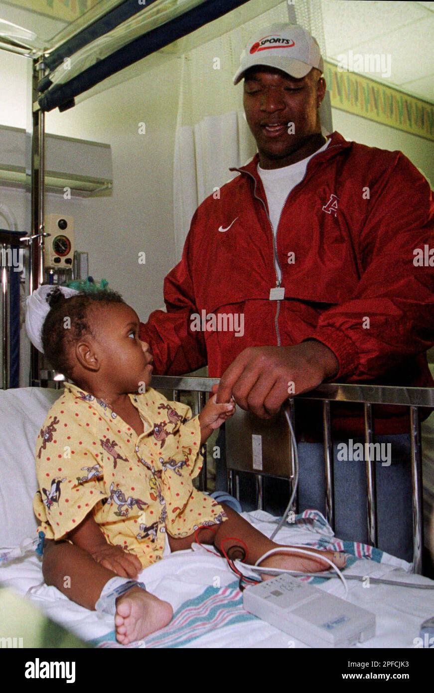 Alabama's Chris Samuels, right, talks to Danielle Hixon, 9 months, left ...