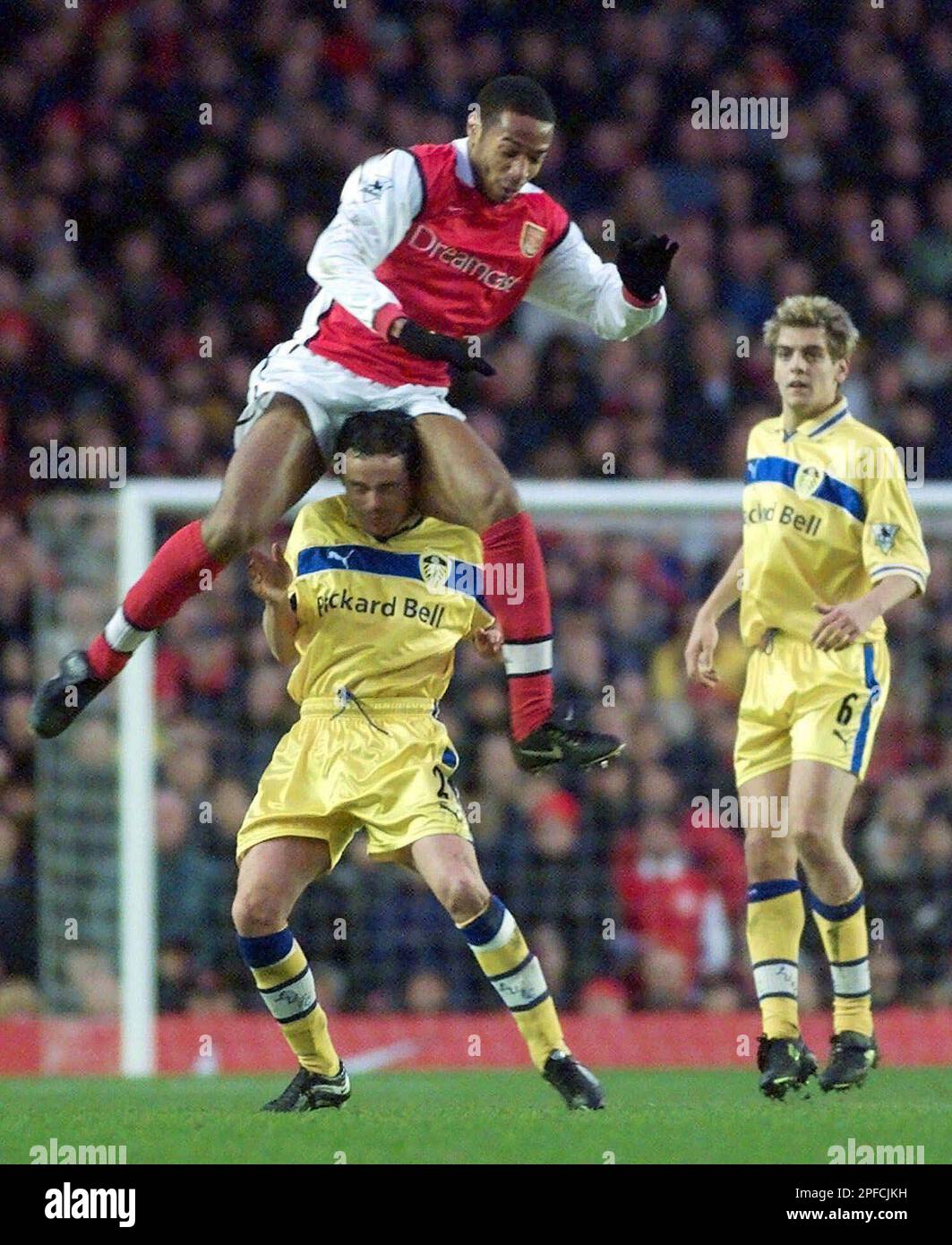 Arsenal's Thierry Henry outjumps Leeds United's Gary Kelly as Jonathan ...