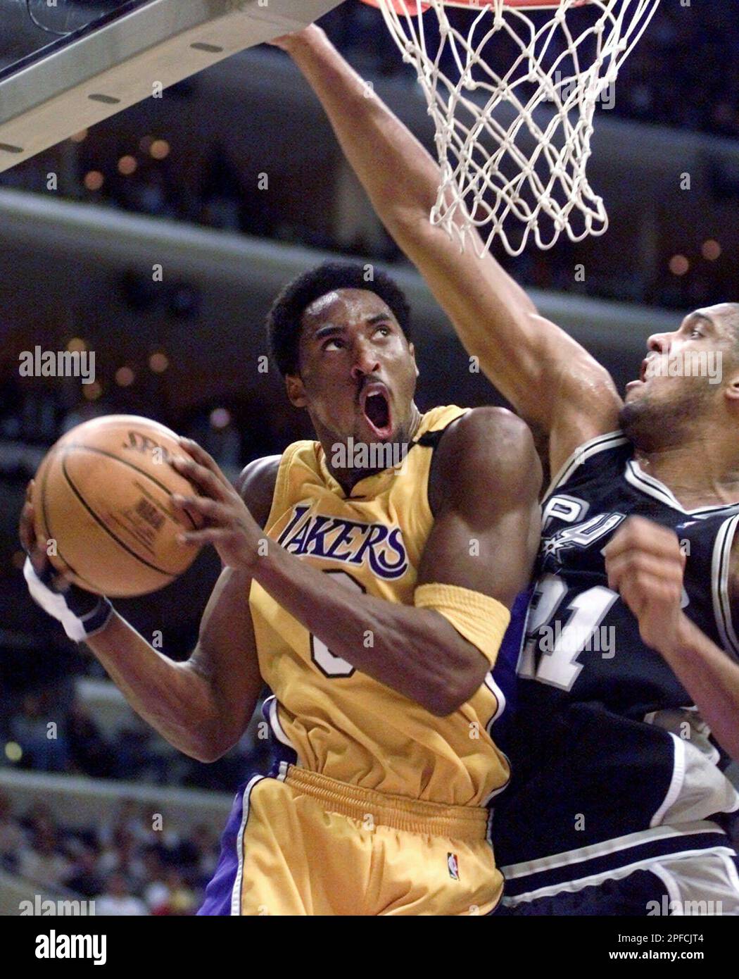 Los Angeles Lakers' Kobe Bryant, left, goes for a layup against San ...