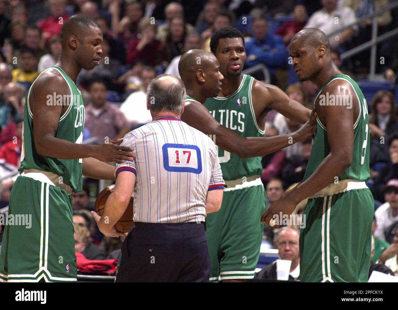 Boston Celtic's Antoine Walker, right, is restrained by his teammates ...