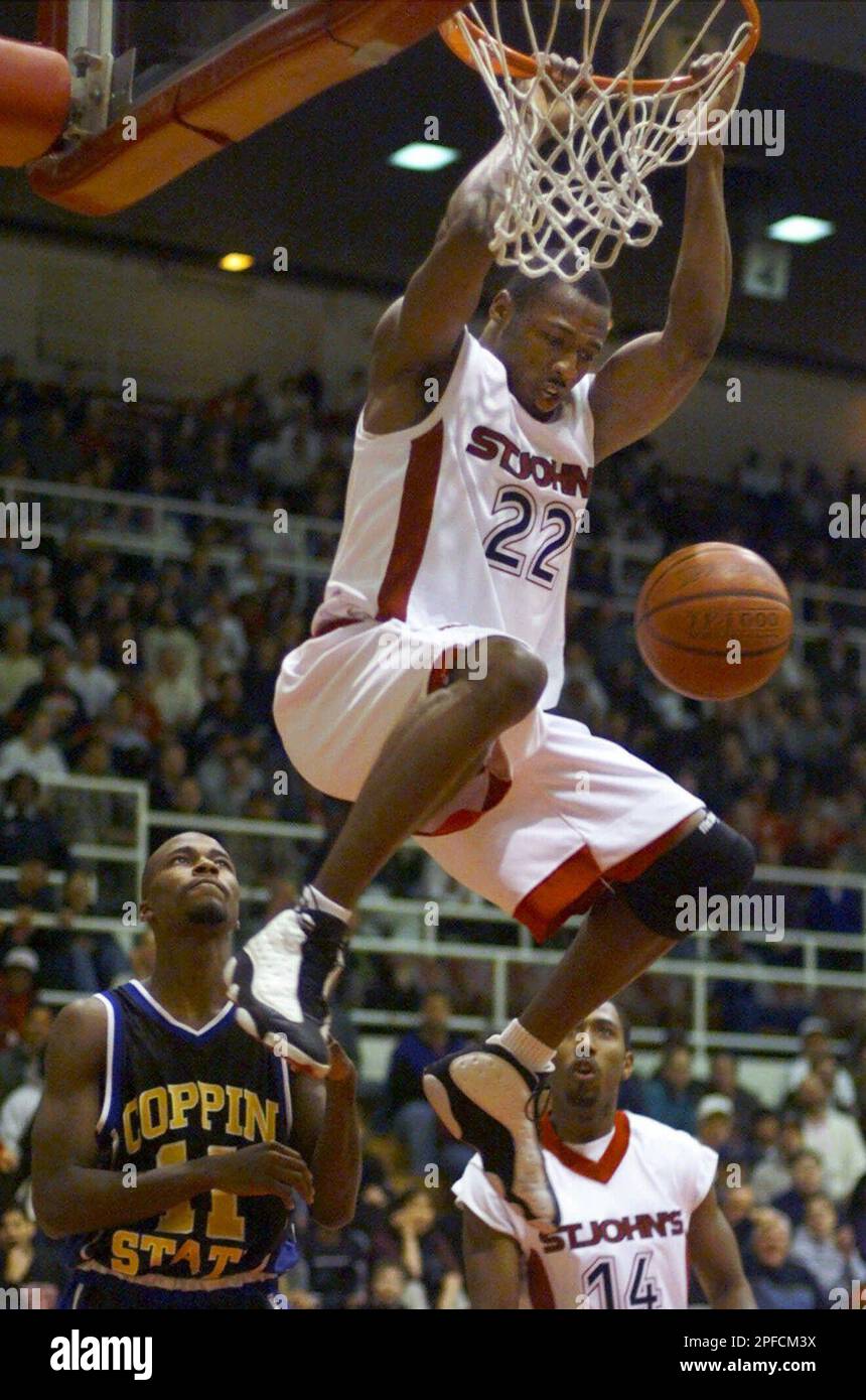 St. Johns' Anthony Glover hangs from the rim after dunking for two ...