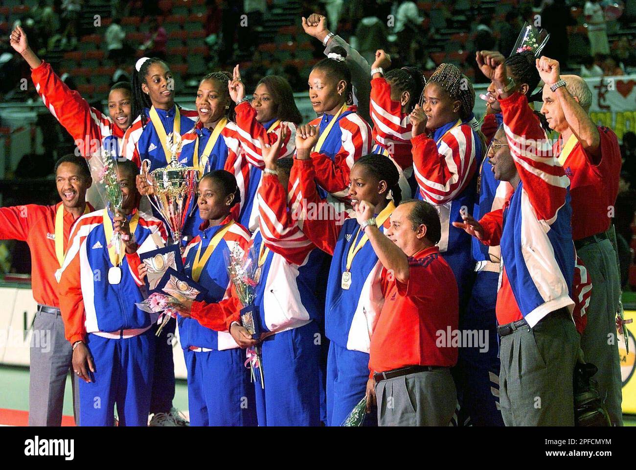 The 'Cuban volleyball team raise their arms for photo during the medal ...