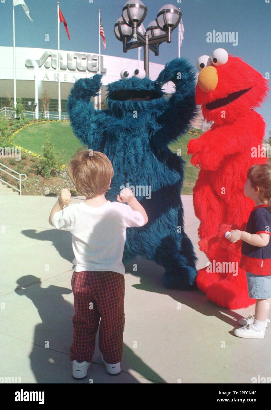 Sesame Street characters Cookie Monster, center back, and Elmo, right ...