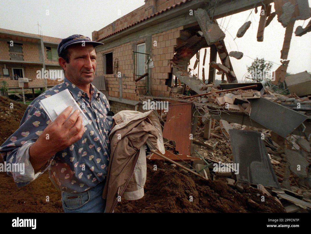 Italian Giuseppe Cervera, 54, stands in front of his demolished home in ...