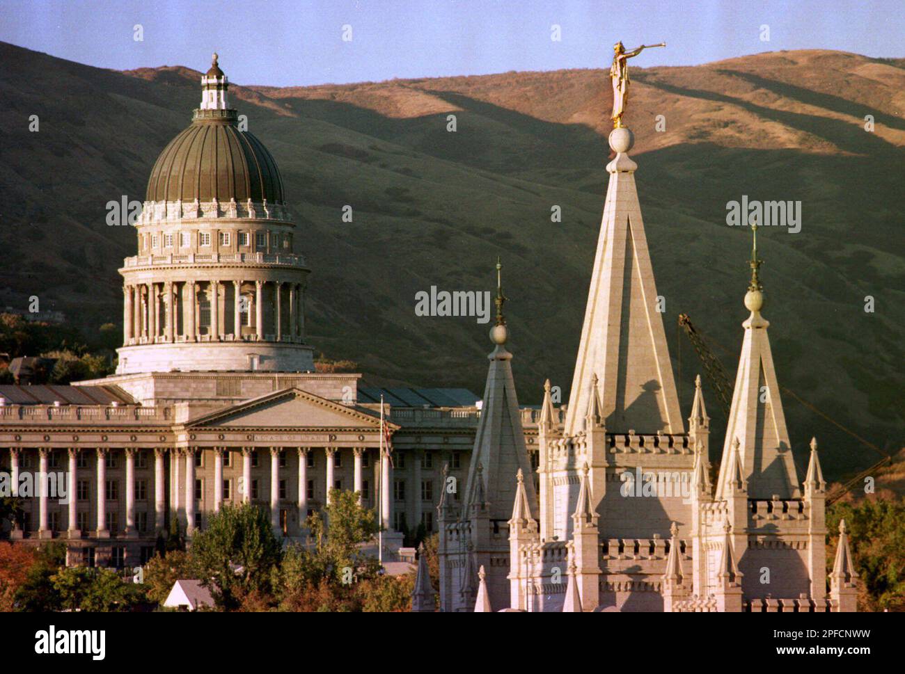 Sun sets on Utah's Capitol Building, left, and the angel-topped spire ...