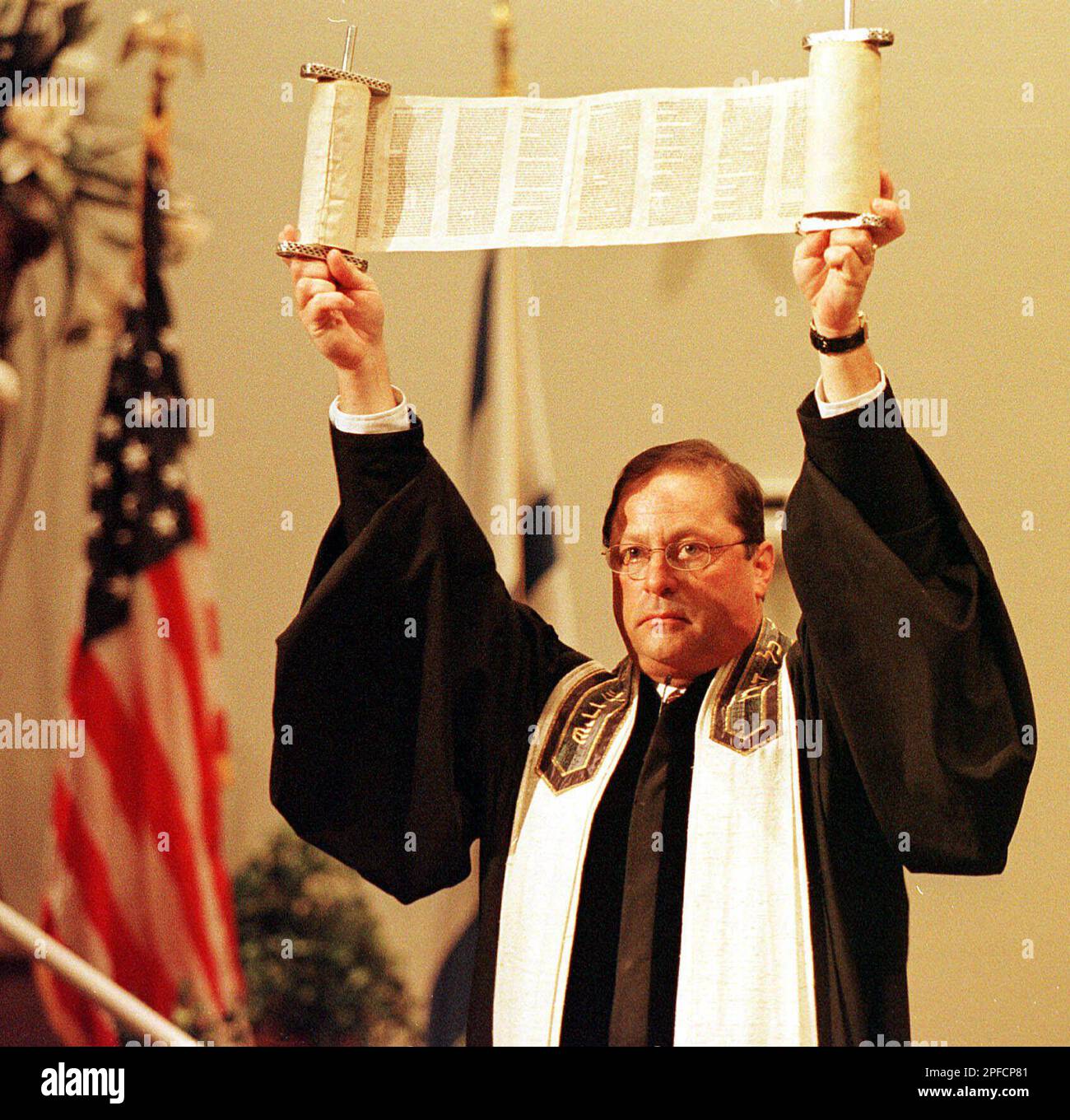 Rabbi Dannel Schwartz carries a rare 14th to 15th century Torah scroll ...