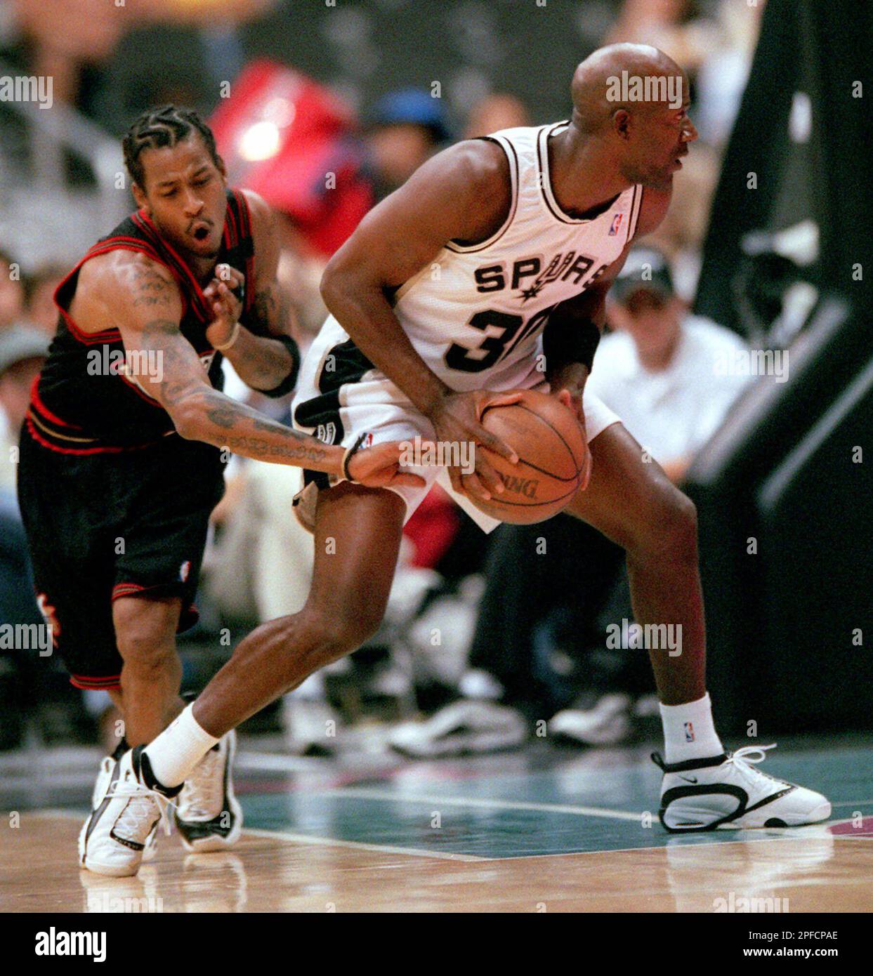 Philadelphia 76ers' Allen Iverson gets a hand on the ball as San ...