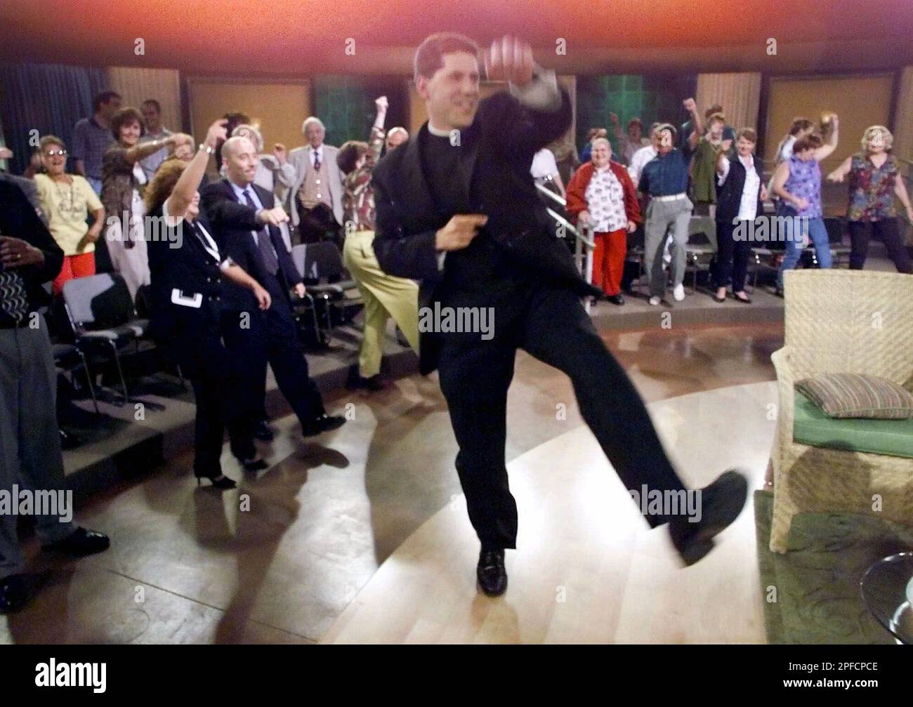 Father Alberto Cutie, center, gets his audience to dance the Hokey ...