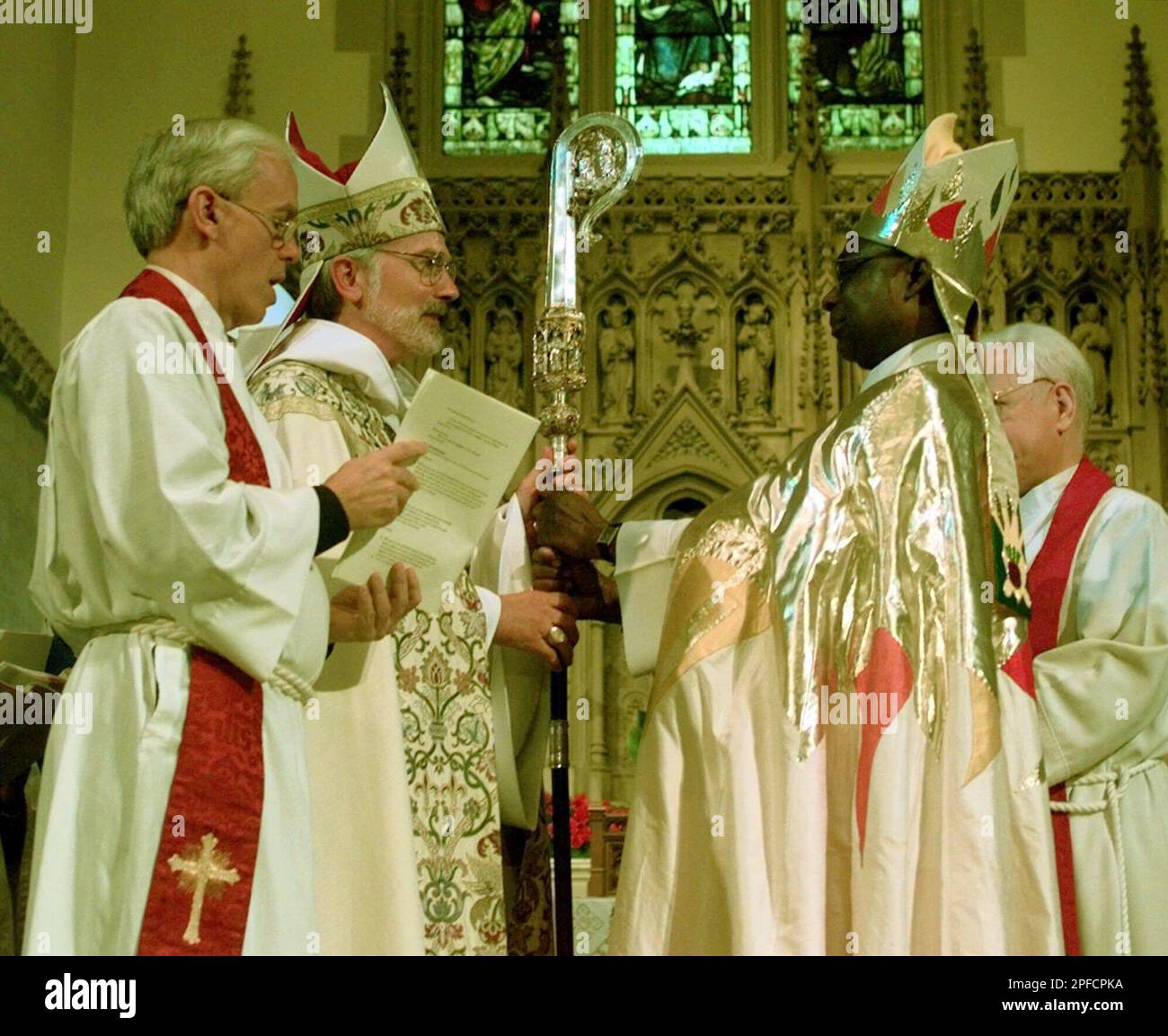 The Right Rev. Andrew Donnan Smith, second from left, receives the ...