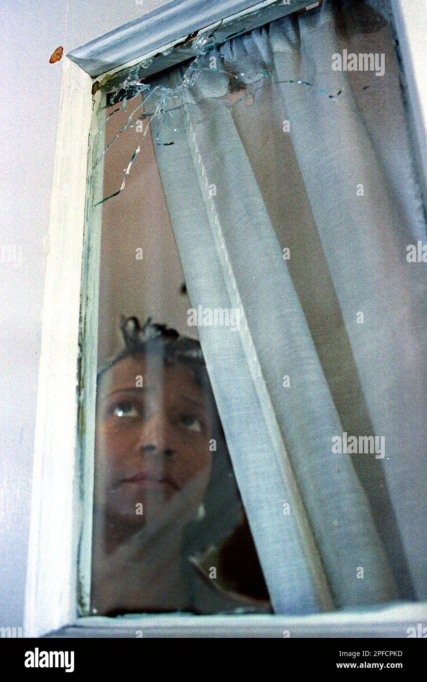 Irvington, N.J., Mayor Sara Bost looks up at a bullet hole in a door to ...