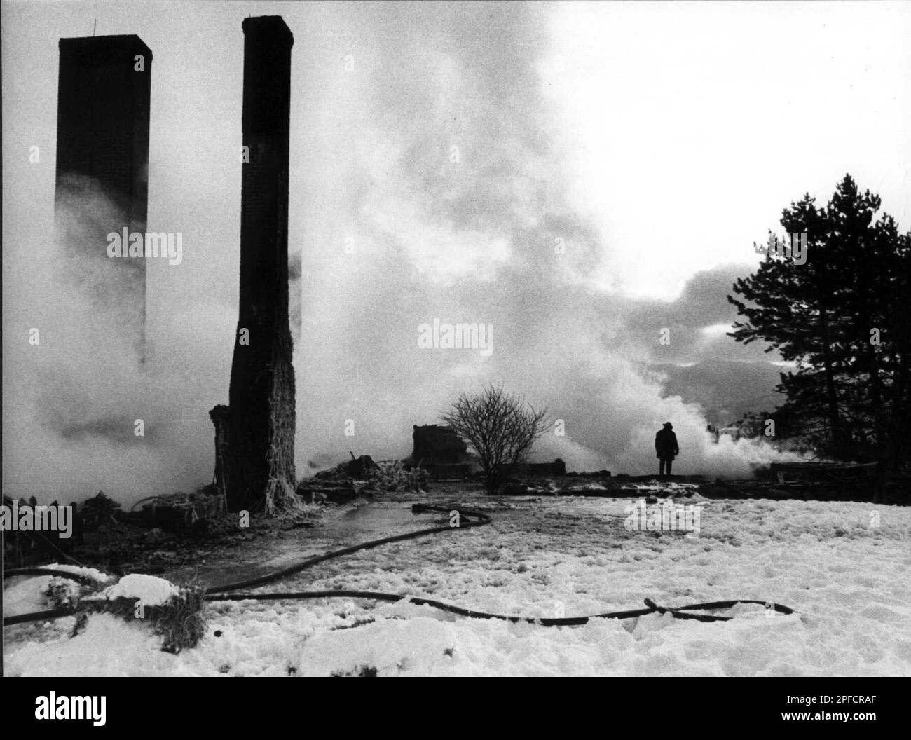 A firefighter looks over all that remains after a fire destroyed the ...