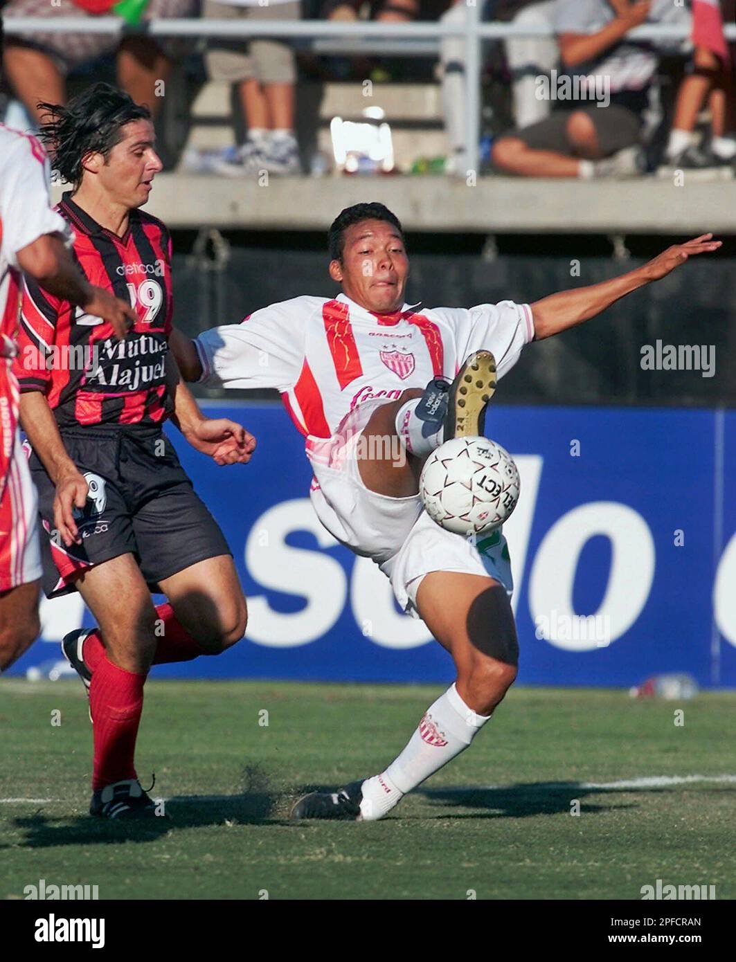 Necaxa's (Mexico) Jaime Hernandez, right, kicks as Alajuela's (Costa ...