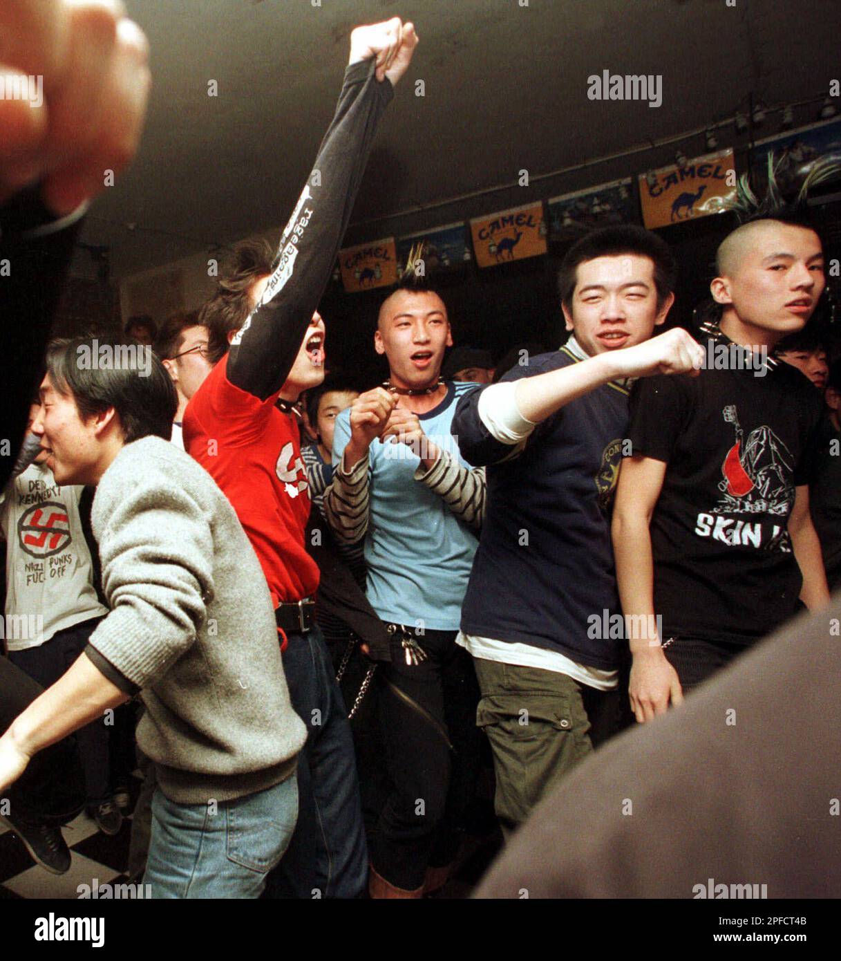 Fans dance to the music of Brain Failure, a young Chinese punk band, at ...