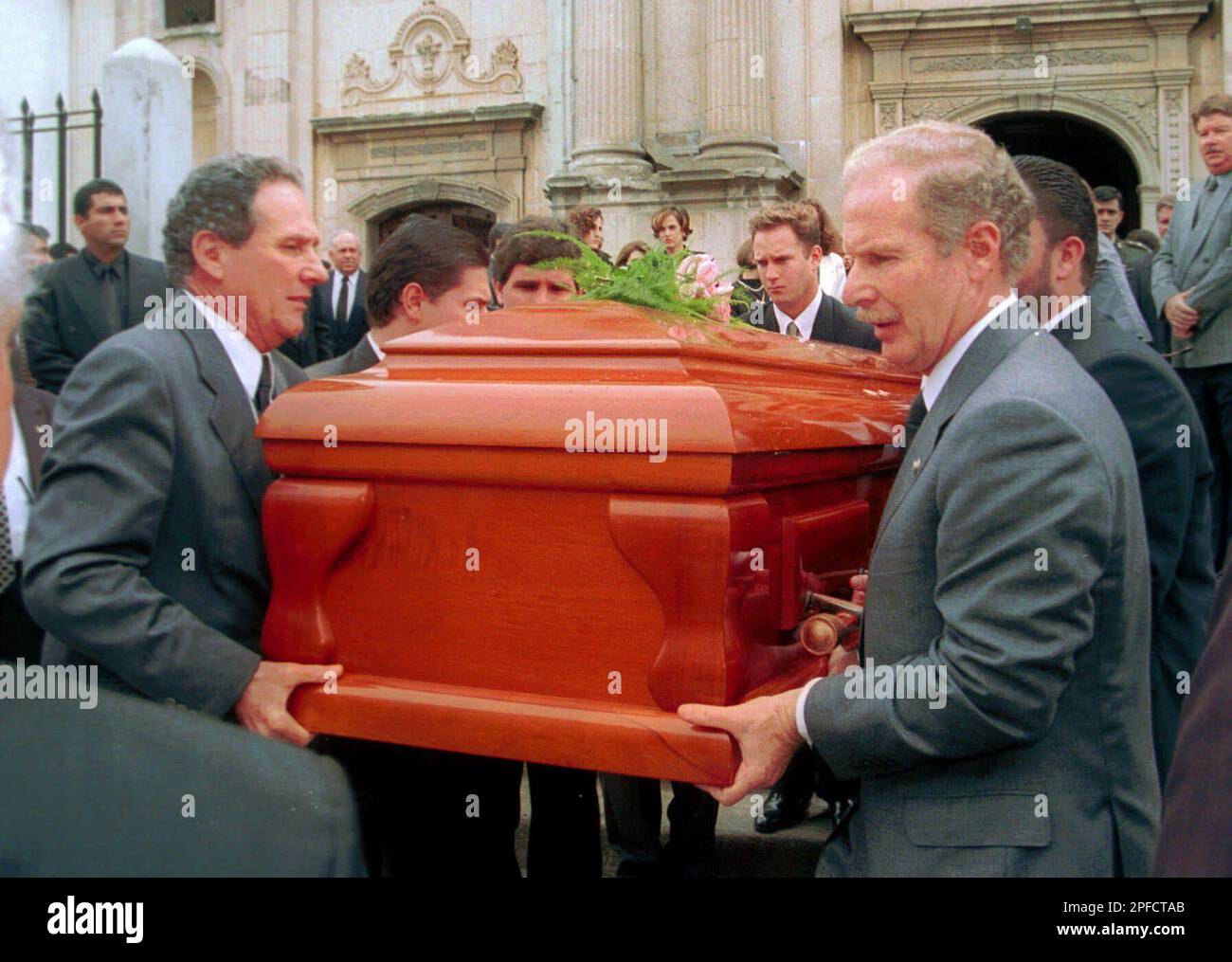 Guatemalan President Alvaro Arzu Irigoyen, right, carries the coffin of ...