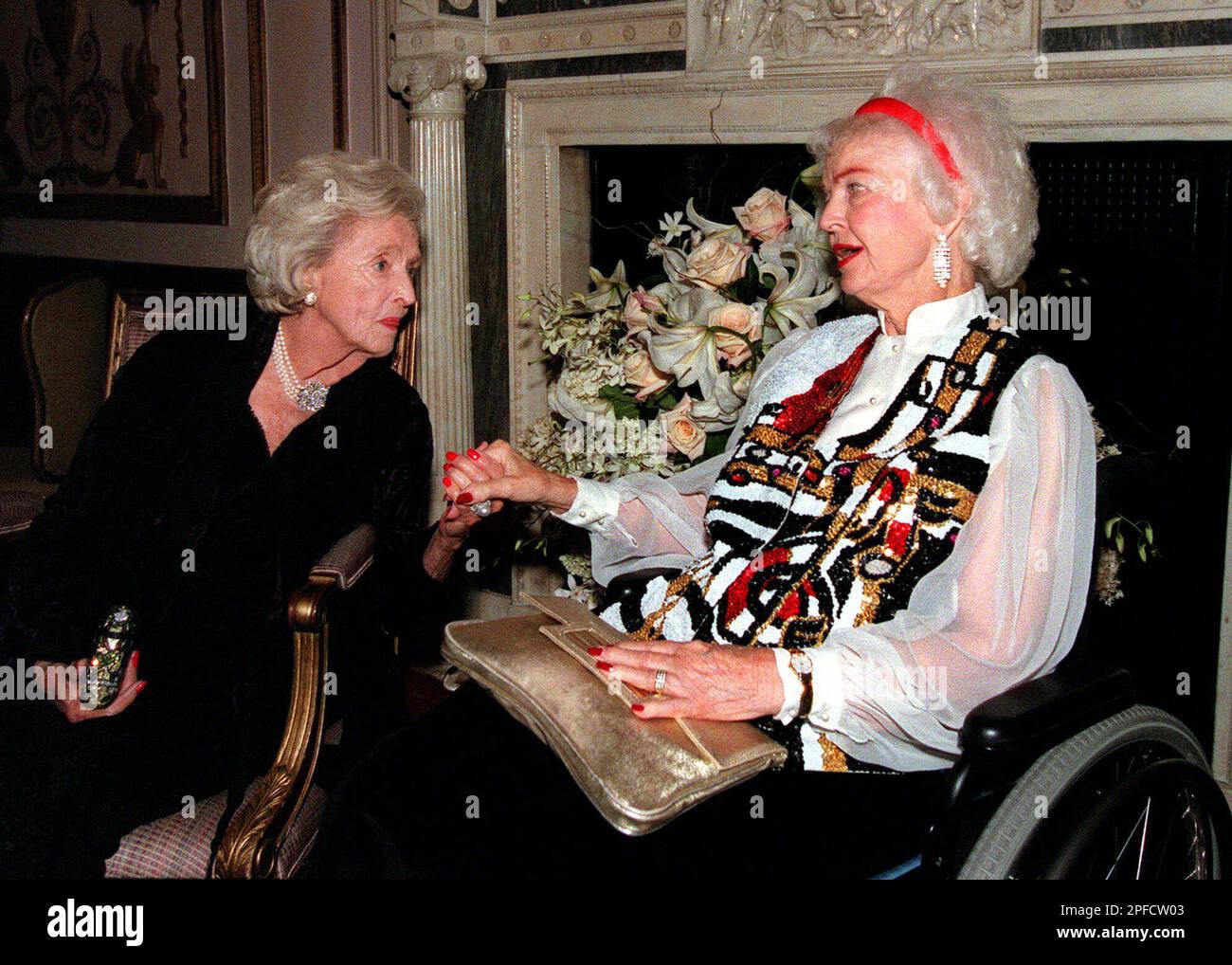 Dolores Hope, left, takes the hand of Dale Evans, former performer and ...
