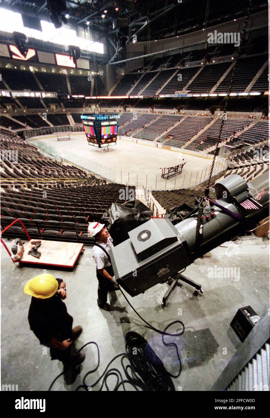 Construction workers Scott Ward, left, and Glenn Strauss, right, guide ...