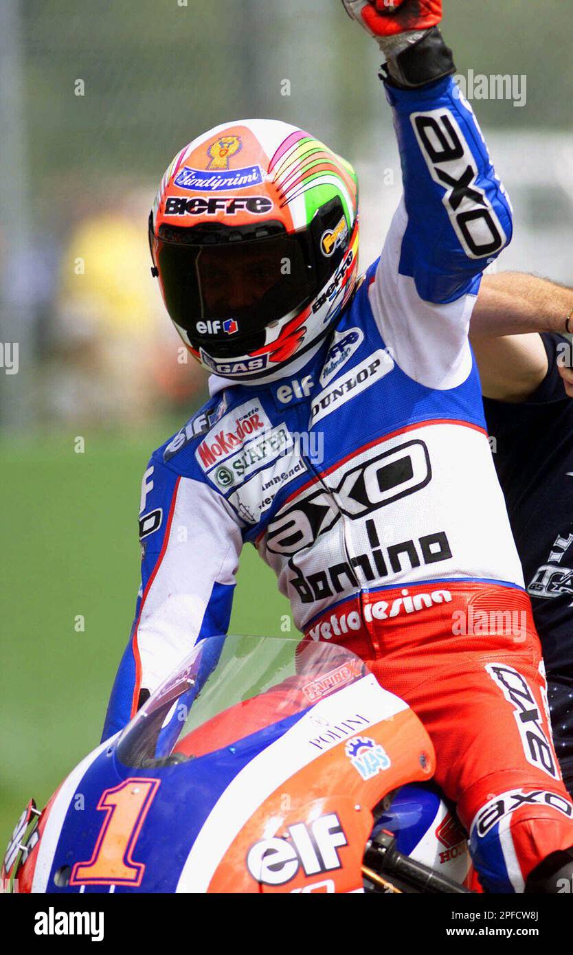 Italy's Loris Capirossi celebrates after taking his Honda 250cc to ...