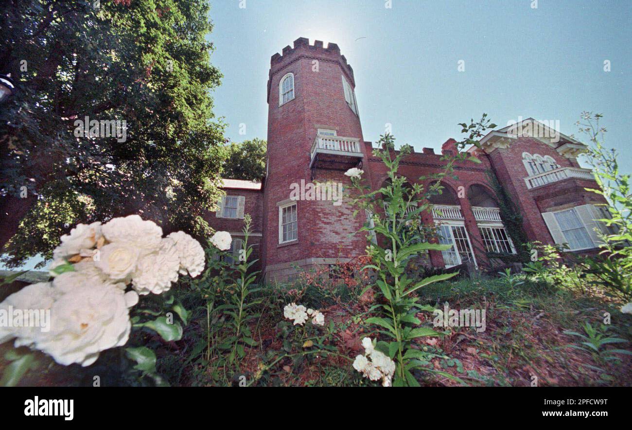 White roses blossom in front of the Nemacolin Castle in Brownsville, Pa ...