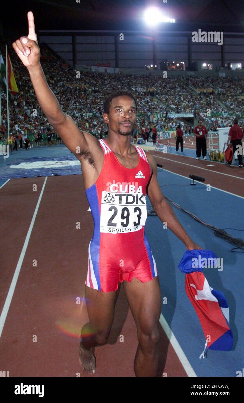 Ivan Pedroso of Cuba celebrates after winning the gold medal in the Men ...