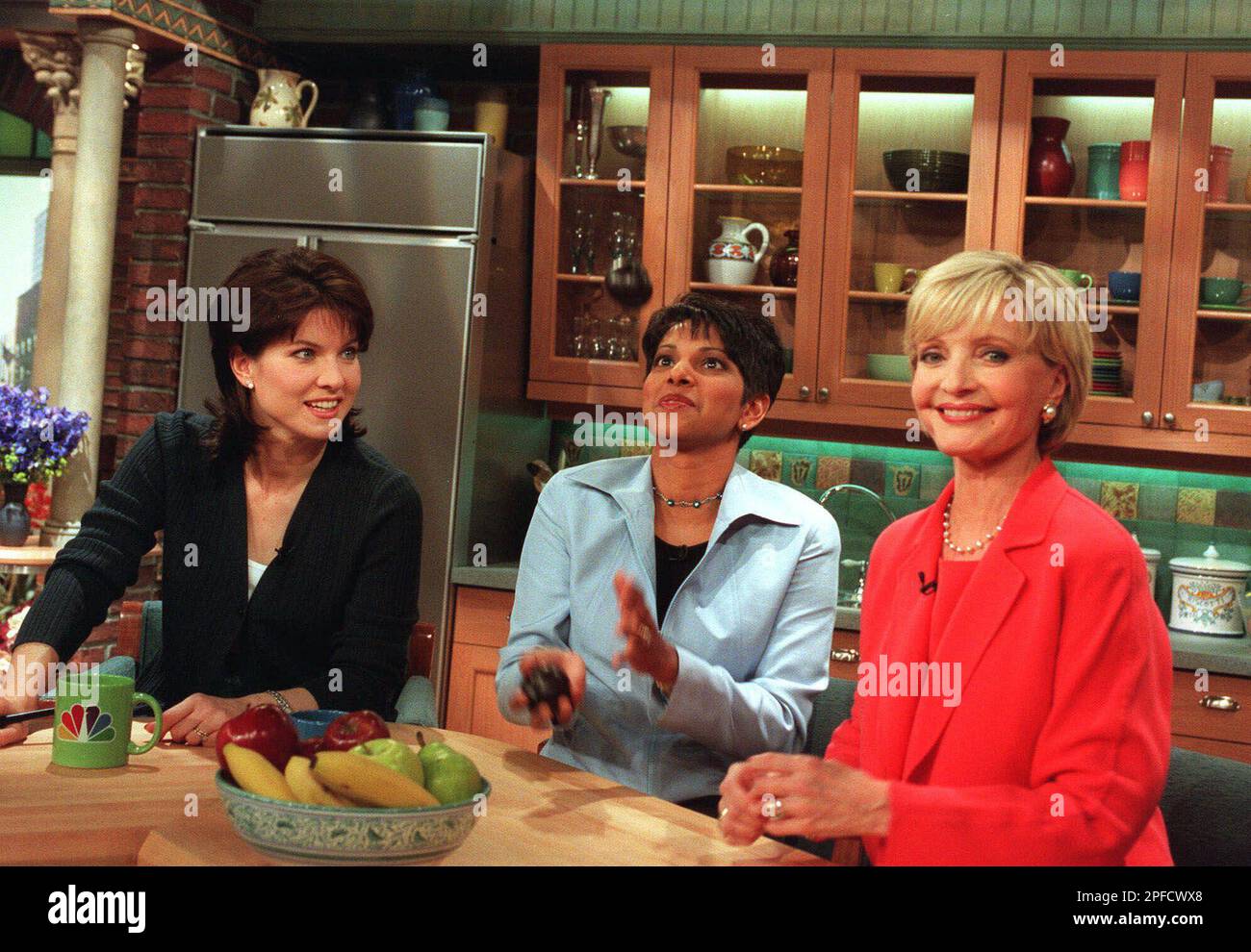 Asha Blake, center, juggles plums to the amusement of Jodi Applegate ...