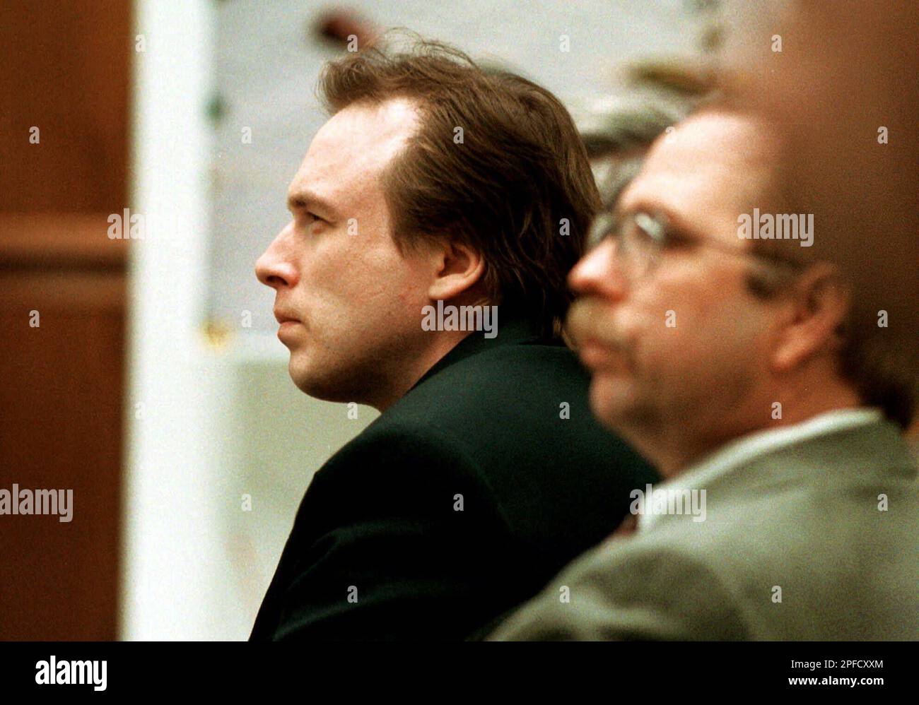 FILE - Scott Yager, left, sits next to public defender John Adams, as ...