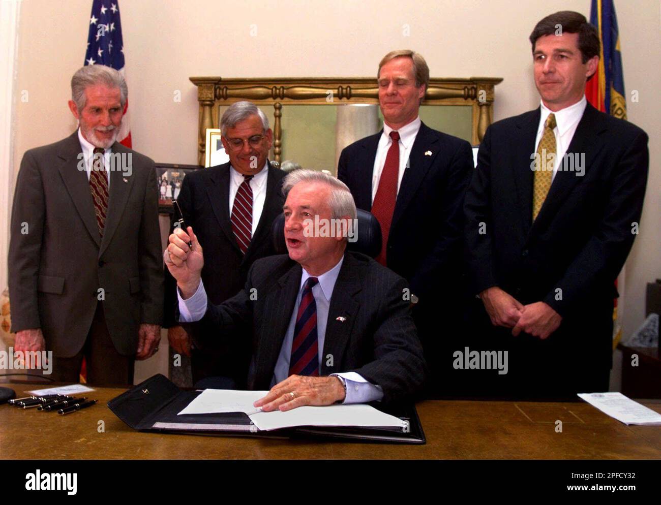North Carolina Gov. Jim Hunt lifts his pen after signing into law the ...