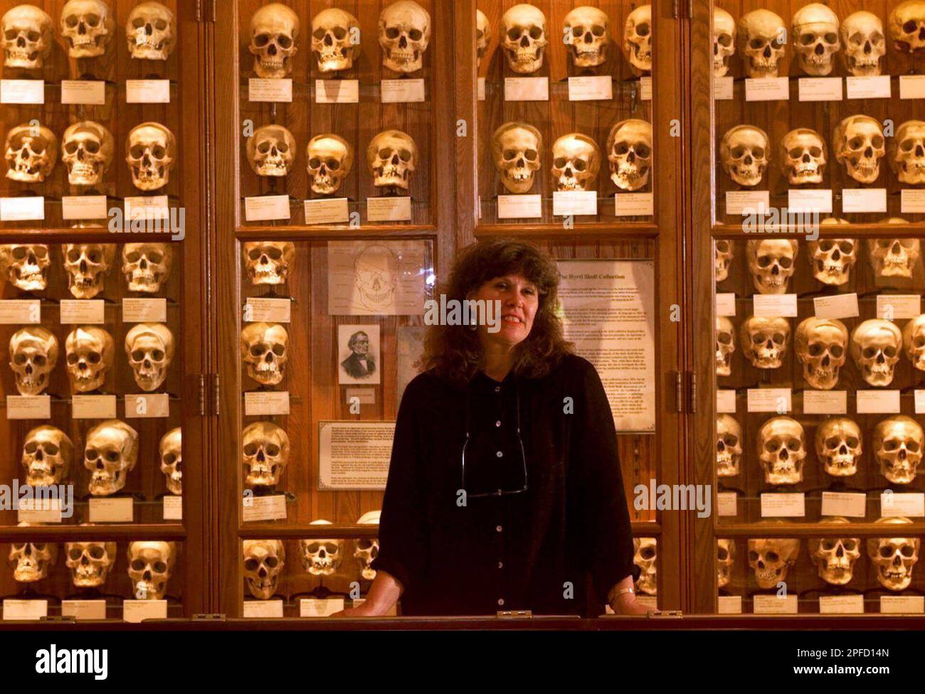 Director Gretchen Worden stands in front of a wall displaying a portion ...