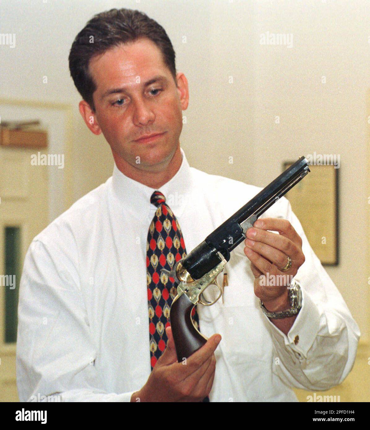 First Assistant District Attorney Bruce Castor holds a replica of a .45 ...