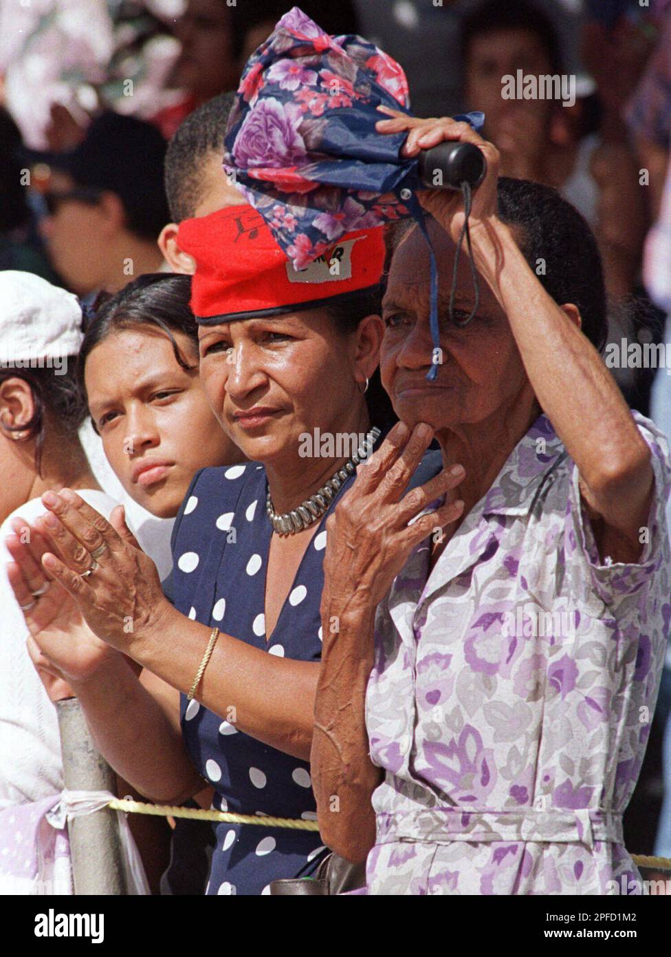 Venezuelan woman with the traditional red beret applauds the military ...