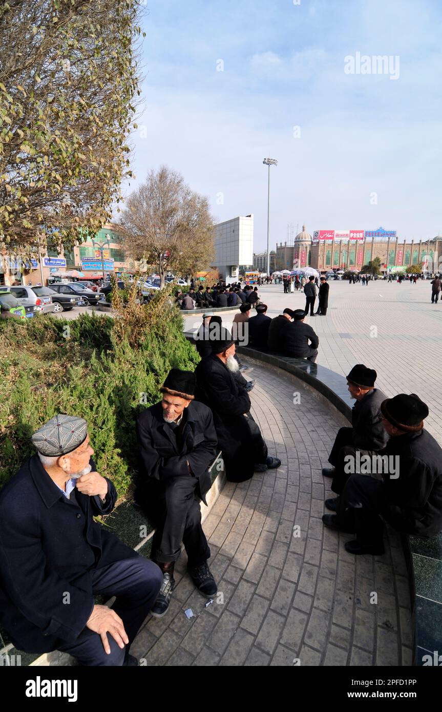 Uyghur men wearing traditional hats. City center of Kashgar, Xinjiang ...