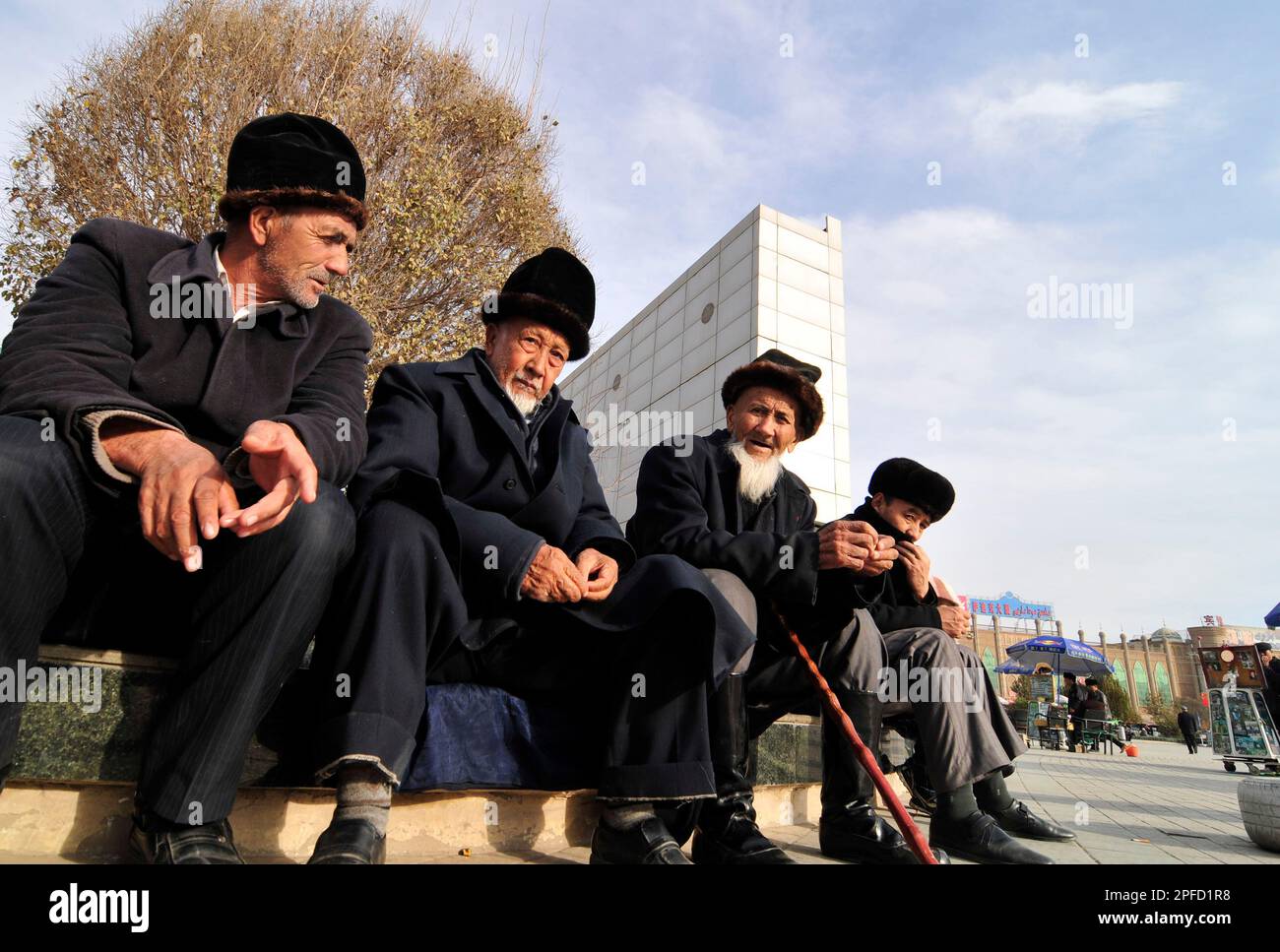 Uyghur men wearing traditional hats. City center of Kashgar, Xinjiang ...