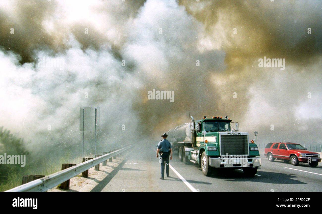 Smoke shrouds the the East and Westbound lanes of RT 195, in Fall River ...