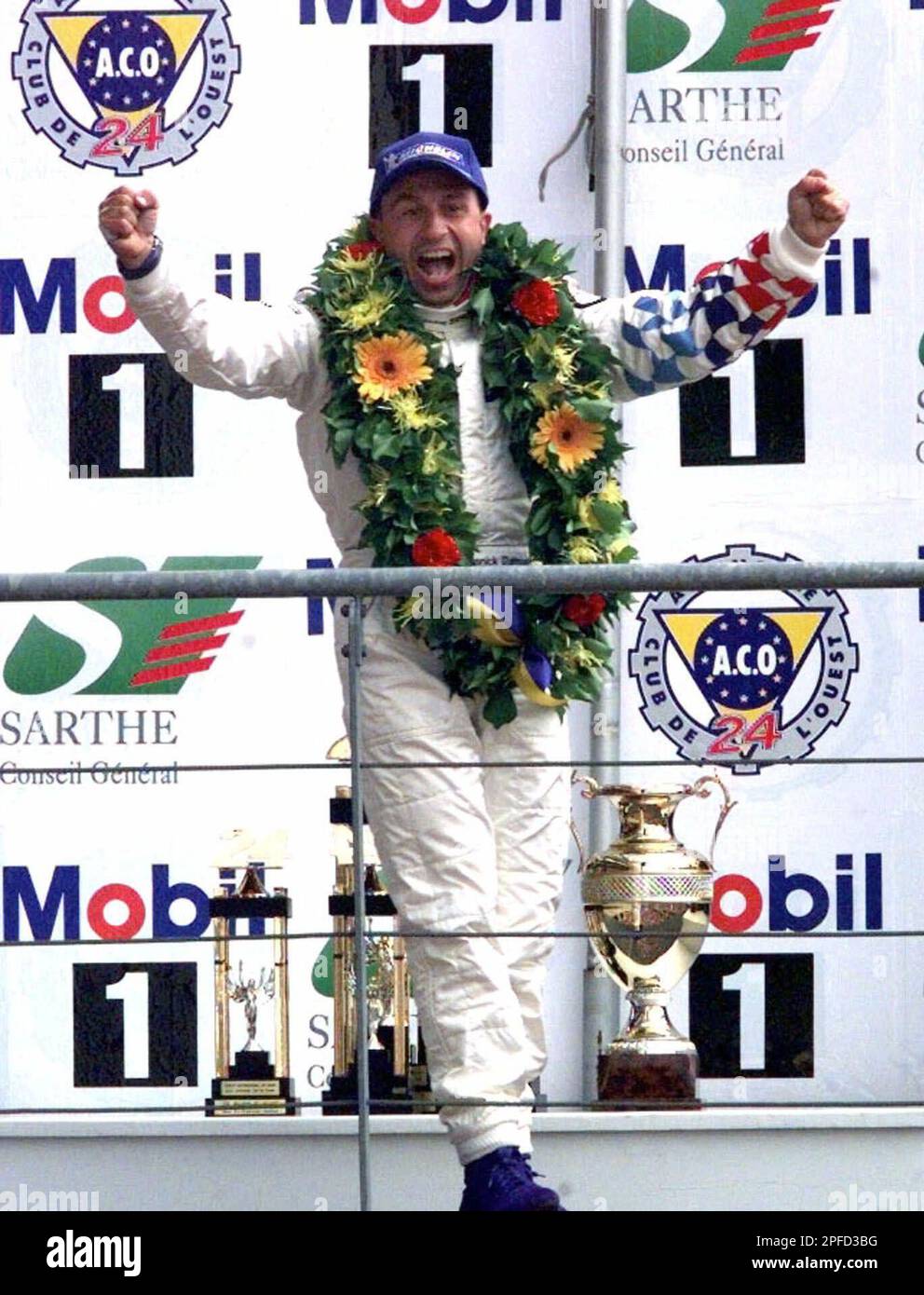 French driver Yannick Dalmas jubilates on the podium after he and co ...