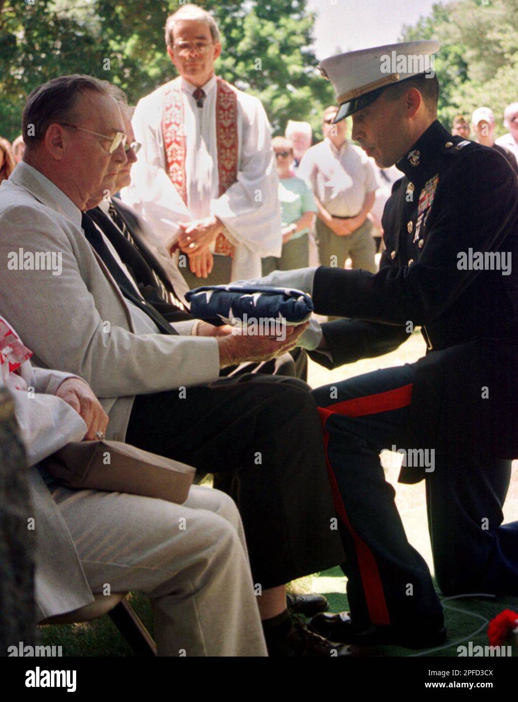 Clifford Holt, left, of North Port, Fla., is handed the American Flag ...