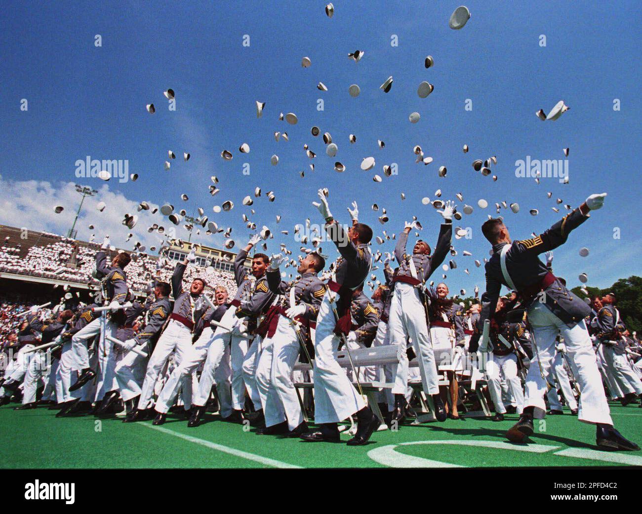 United States Military Academy 1999 graduates toss their hats in the ...
